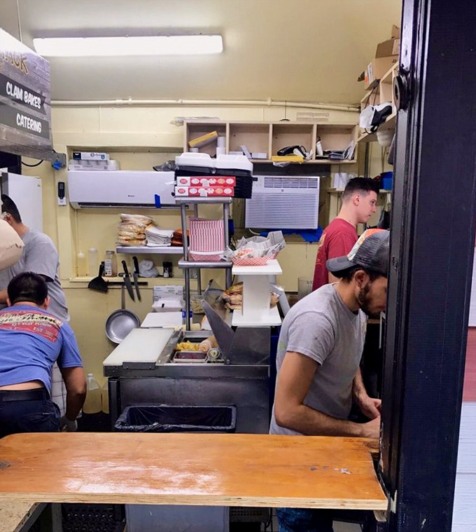 Behind the scenes, the kitchen crew works their magic in tight quarters, proving once again that greatness rarely requires excessive space.