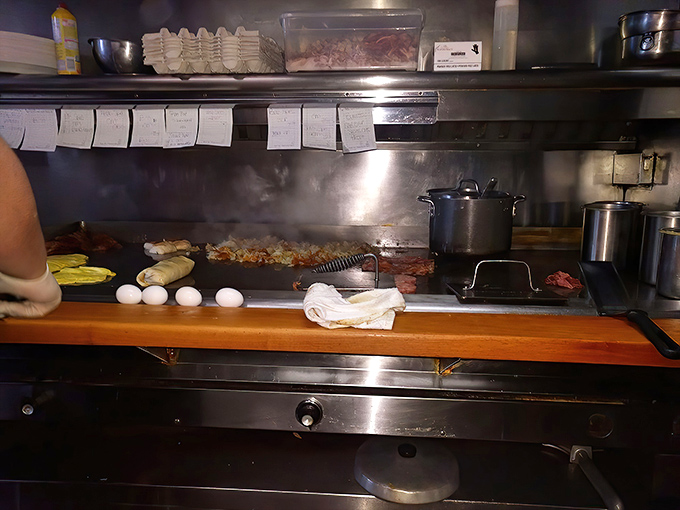 The choreography of a short-order kitchen is a disappearing art form. Eggs, bacon, and potatoes dance across the grill in practiced rhythm.