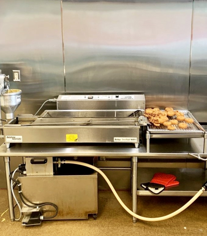 Where the magic happens: fresh donuts emerging from the fryer before their transformation into works of edible art.