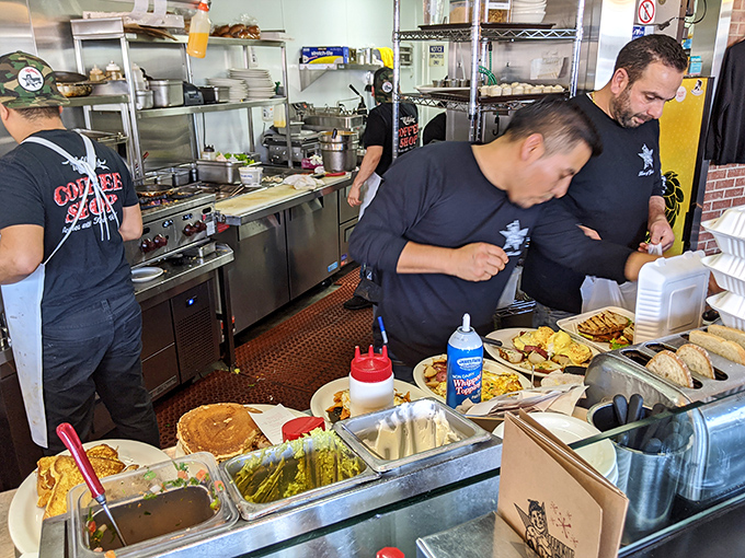 The kitchen crew orchestrates breakfast symphonies while that pickle jar holds court like a briny sentinel.