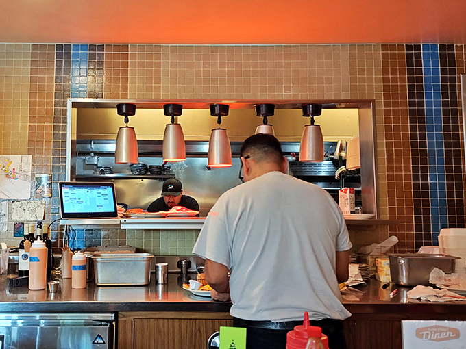 Behind the scenes, where breakfast magic happens—each plate emerging from this window is someone's imminent moment of joy.