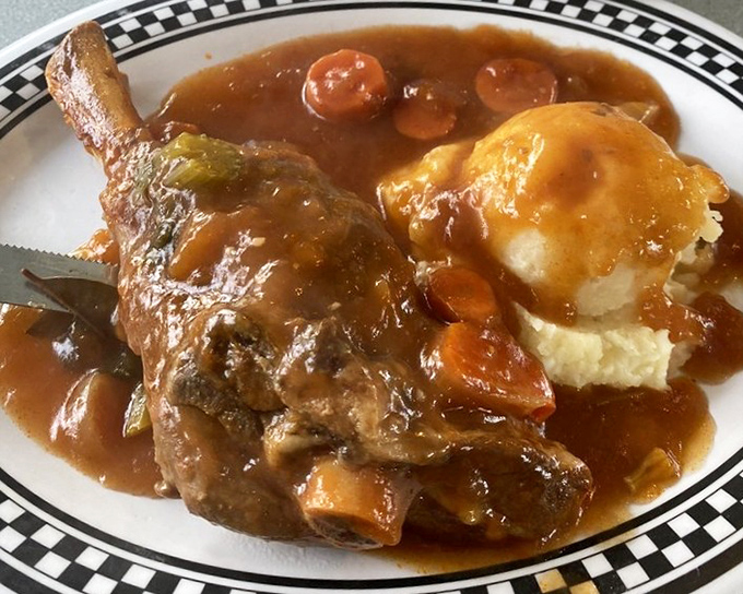 Fall-off-the-bone tender lamb shank swimming in rich gravy alongside mashed potatoes &ndash; comfort food that transcends cultural boundaries.