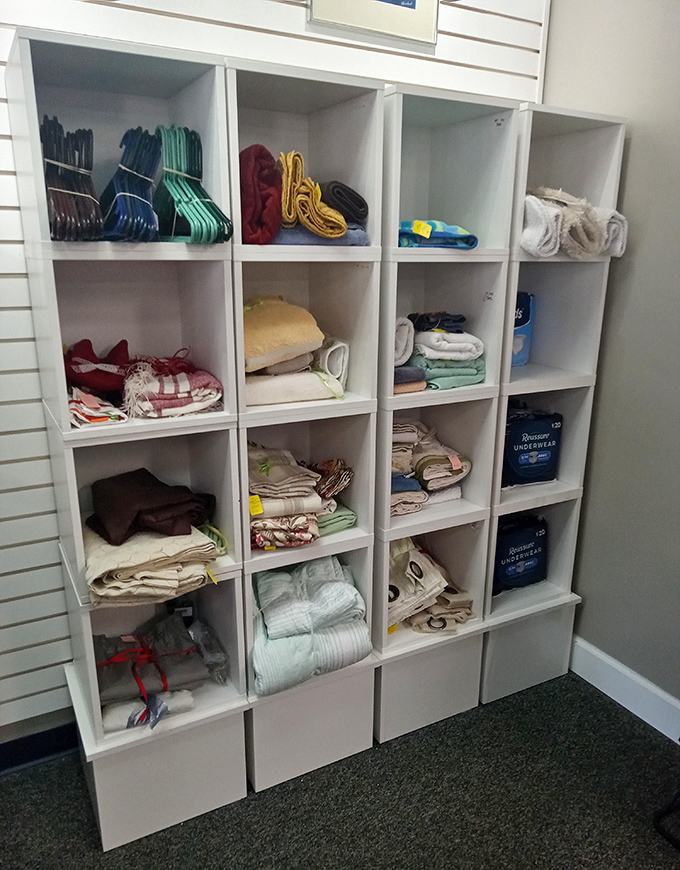 Neatly folded linens, towels, and bedding fill organized cubbies, proving that second-hand shopping doesn't mean sacrificing order or quality.