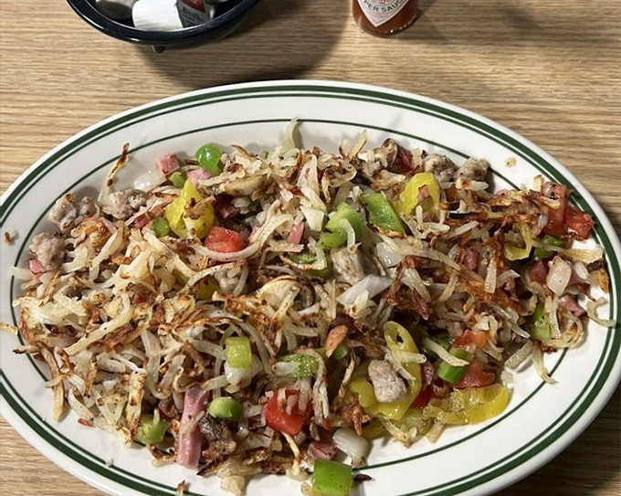 Hash browns living their best life, loaded with colorful peppers and savory additions. Potato perfection that makes breakfast feel like a celebration.