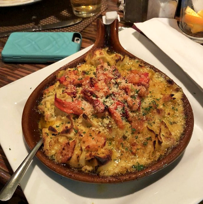 Pasta swimming in creamy sauce with tomatoes and seafood joining the party. This dish makes you want to twirl your fork for eternity.