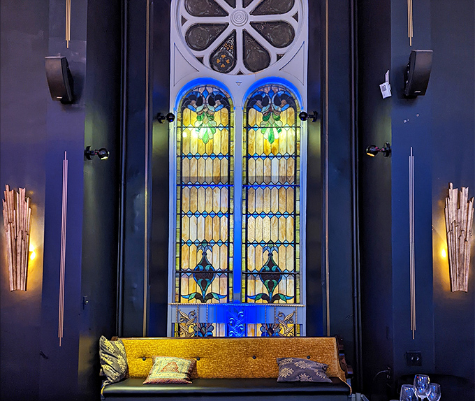 Stained glass windows bathe the lounge in jewel-toned light, turning your pre-dinner cocktail into a moment worthy of a Renaissance painting.