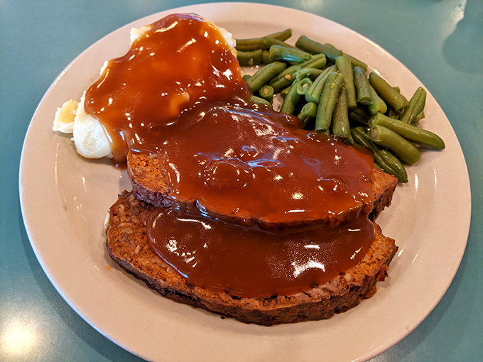 Meatloaf that doesn't apologize for being meatloaf, smothered in gravy that's clearly not counting calories. Comfort food that hugs your soul.
