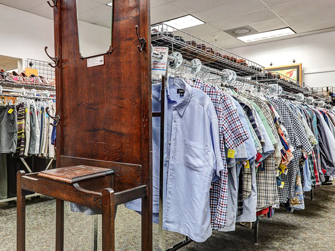 The men's department features a handsome antique hall tree standing guard over rows of button-downs. Business casual meets vintage charm.