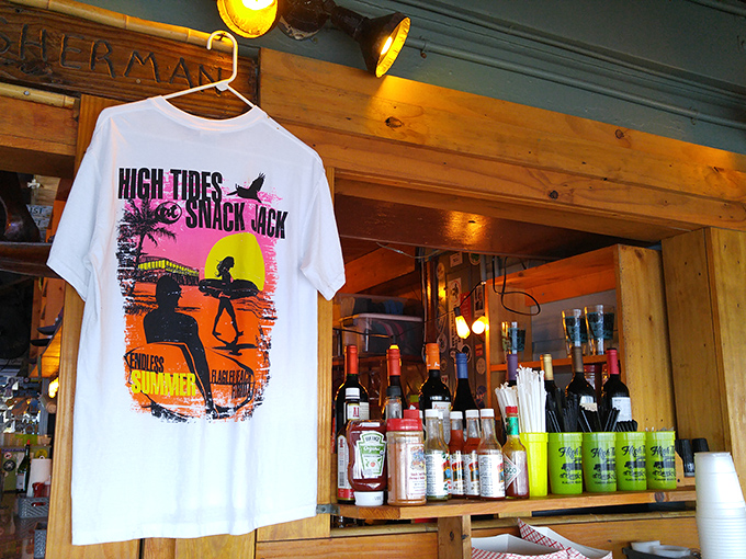 Surf culture meets souvenir culture on a t-shirt that captures the "Endless Summer" vibe that High Tides at Snack Jack has bottled and served for decades.