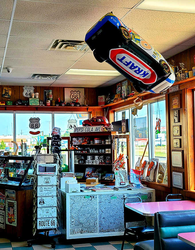 The merchandise corner is a time capsule on steroids. That race car hanging from the ceiling has witnessed more happy meals than most family dining rooms.