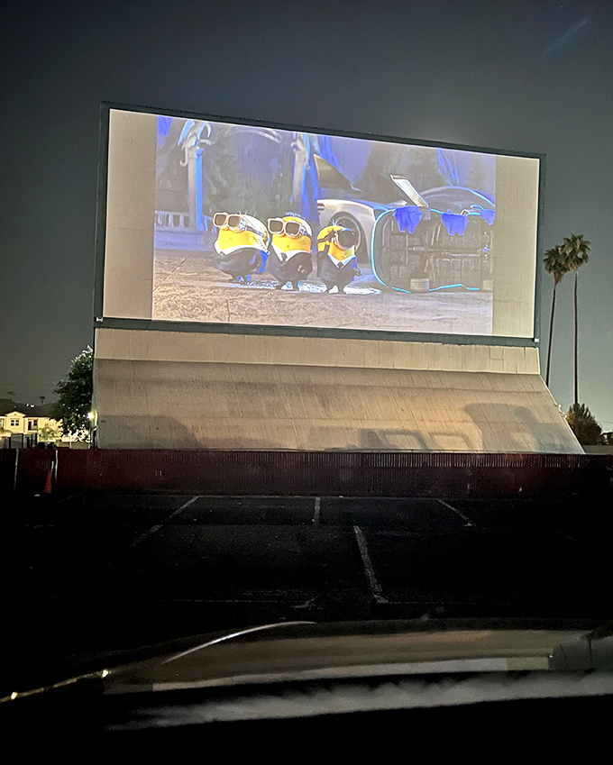 Minions dominate the massive screen, their yellow antics magnified to drive-in proportions against the darkening Riverside sky.