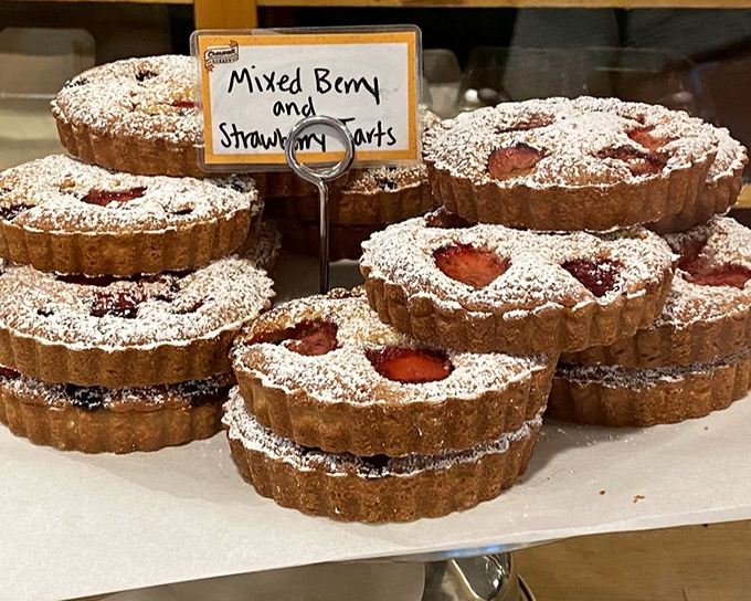 Berry tarts dusted with powdered sugar, where fruit and pastry achieve that perfect sweet-tart harmony that makes your taste buds applaud.