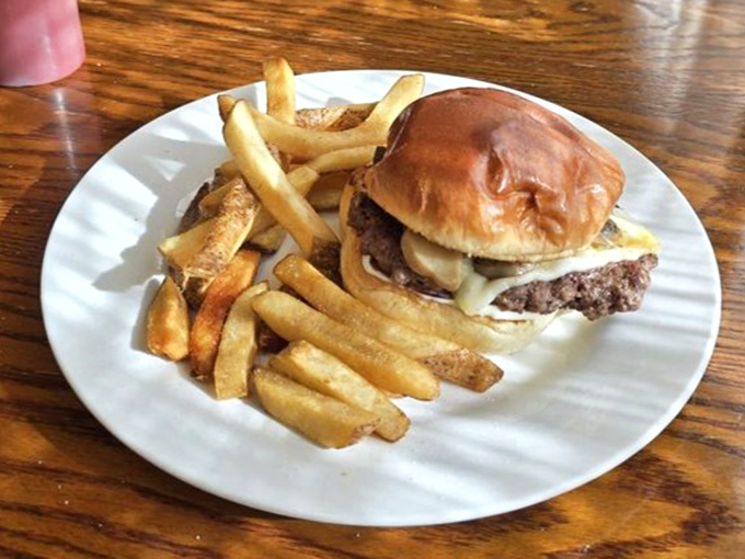 A burger that doesn't need fancy aioli or artisanal buns to impress&mdash;just honest beef, melted cheese, and fries that remind you of simpler times.