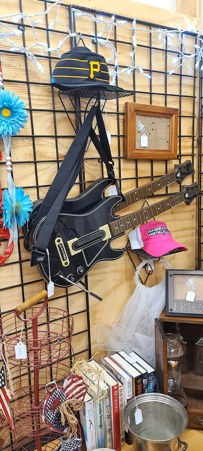 Musical instruments and sports memorabilia create an unexpected harmony. That guitar is just waiting to star in someone's garage band dreams.