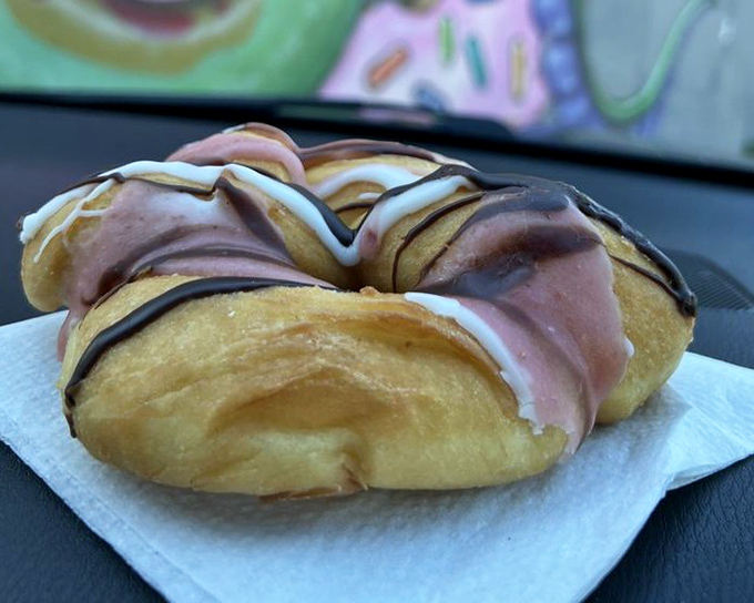 This pillowy creation, swirled with chocolate and vanilla, looks like it's wearing a fancy outfit to the donut prom. Dressed to impress on its paper napkin runway.