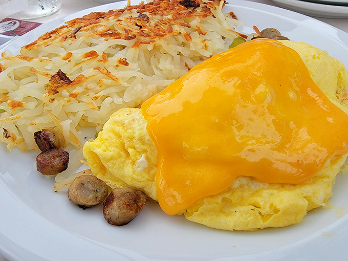 This omelet draped in melted cheese alongside crispy hash browns proves that sometimes the most photogenic food isn't fancy&mdash;it's just perfectly executed.