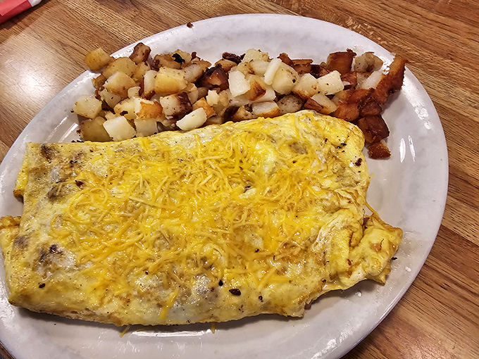 An omelet so perfectly executed it deserves its own Instagram account, paired with home fries that make you question all other potatoes.