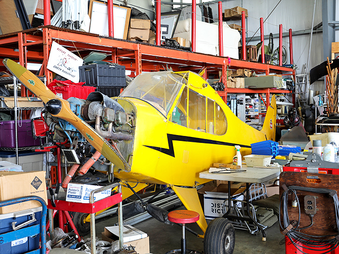 The imposing presence of a B-25 bomber draws crowds at an airshow, its polished aluminum skin gleaming under the summer sun.