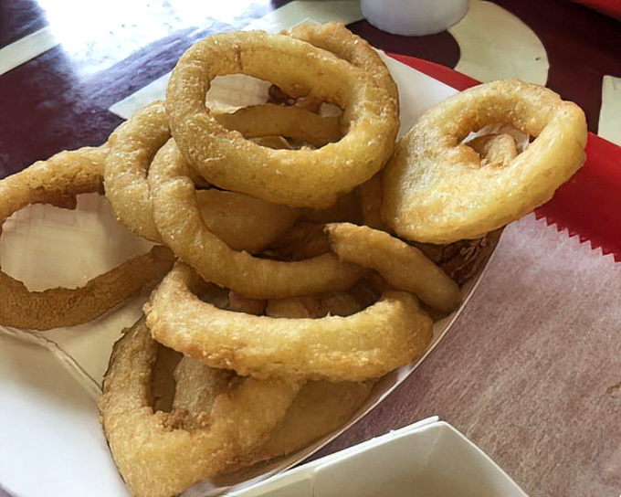 Onion rings with the perfect crunch-to-tenderness ratio &ndash; golden halos of happiness that make you wonder why anyone would settle for fries.