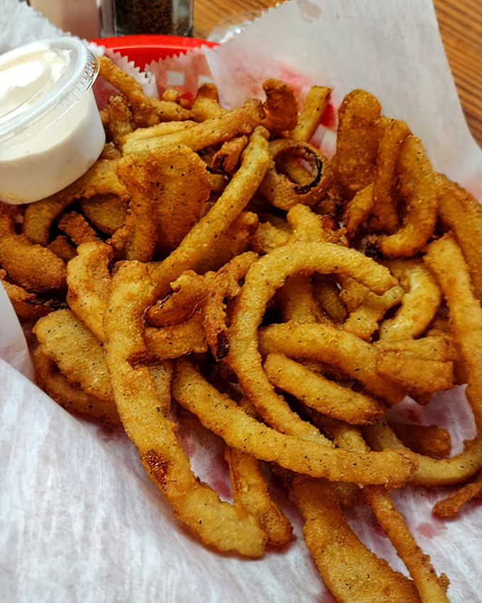 Golden-brown onion straws that crunch like autumn leaves, except these leaves make you say "mmm" instead of "time to rake again."