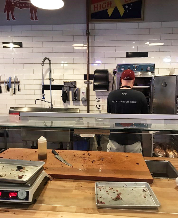 In the open kitchen, barbecue magic happens without smoke and mirrors &ndash; just smoke, skill, and a t-shirt that speaks the truth.