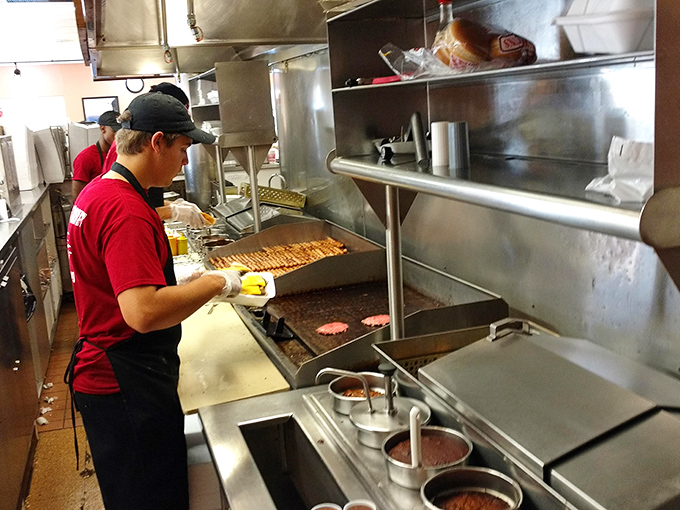 Behind the scenes, where the magic happens—hot dogs getting the royal treatment from hands that have perfected the craft through thousands of repetitions.