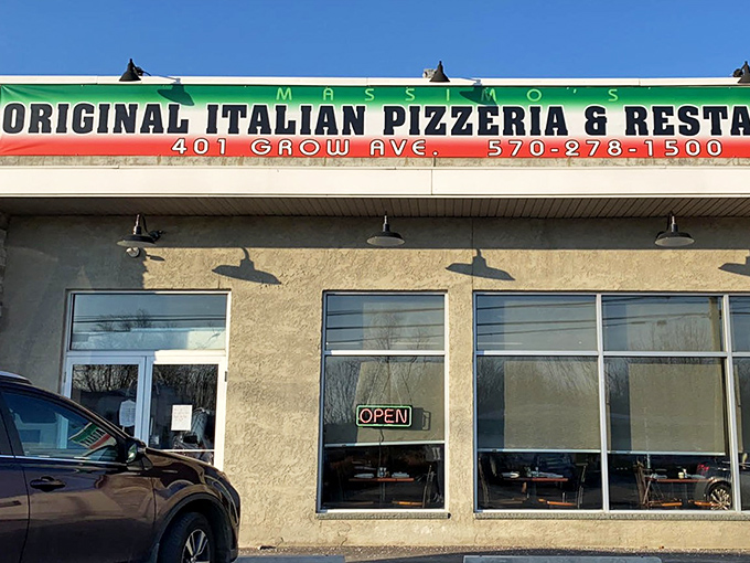 That green and red sign promises authentic Italian comfort food in true neighborhood pizzeria fashion.