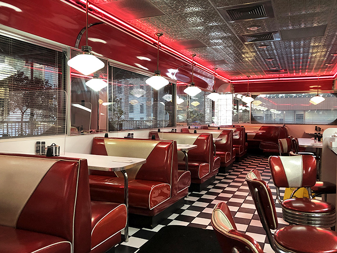 Red vinyl booths stretch into infinity, each one a potential setting for first dates, family breakfasts, or solving the world's problems over coffee.