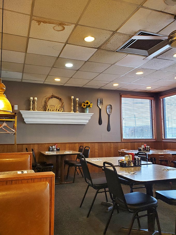 Cozy corners and oversized utensil decor create that "grandma's kitchen meets professional diner" vibe that somehow makes everything taste even better.