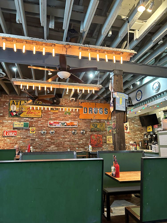 Vintage signs adorn exposed brick walls beneath string lights, creating an atmosphere that feels like a hug from your coolest, food-loving friend.