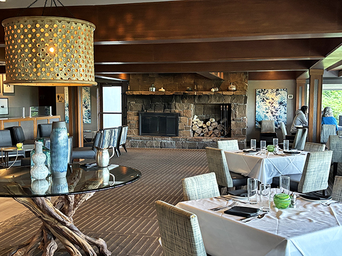 That stone fireplace isn't just architectural&mdash;it's the heart of the dining room, warming both the space and conversations between bites of brilliance.