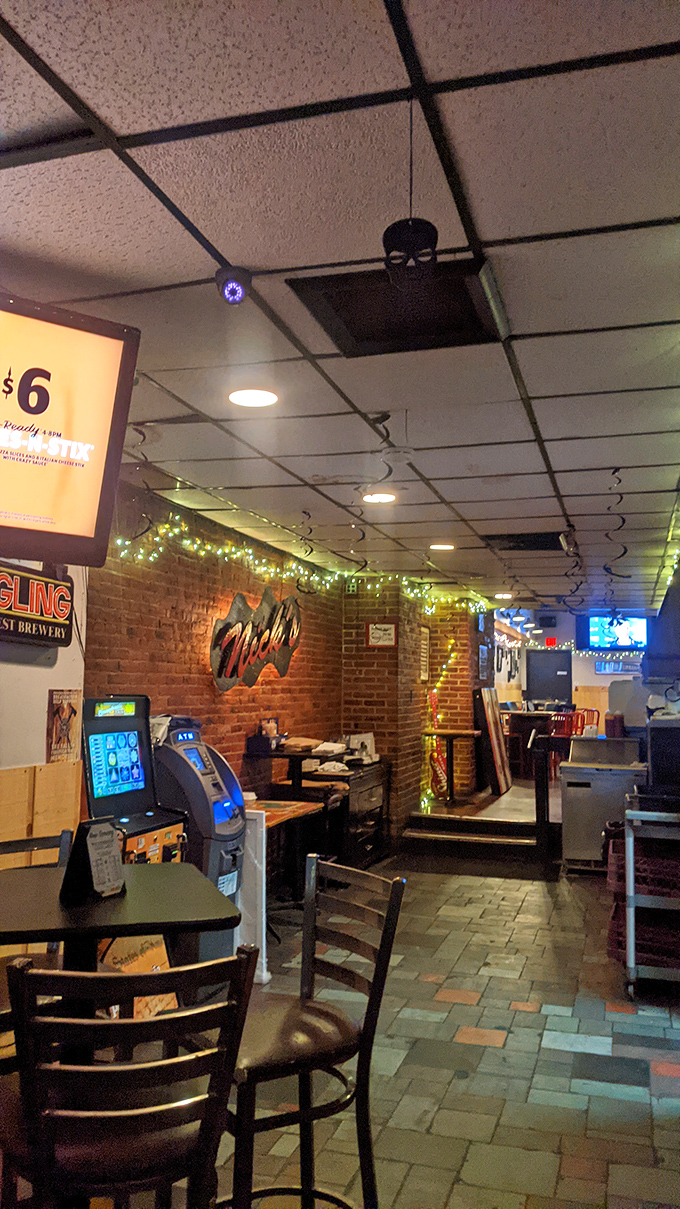 String lights, brick walls, and that distinctive Nick's sign create an atmosphere that says "stay awhile" without having to say a word.