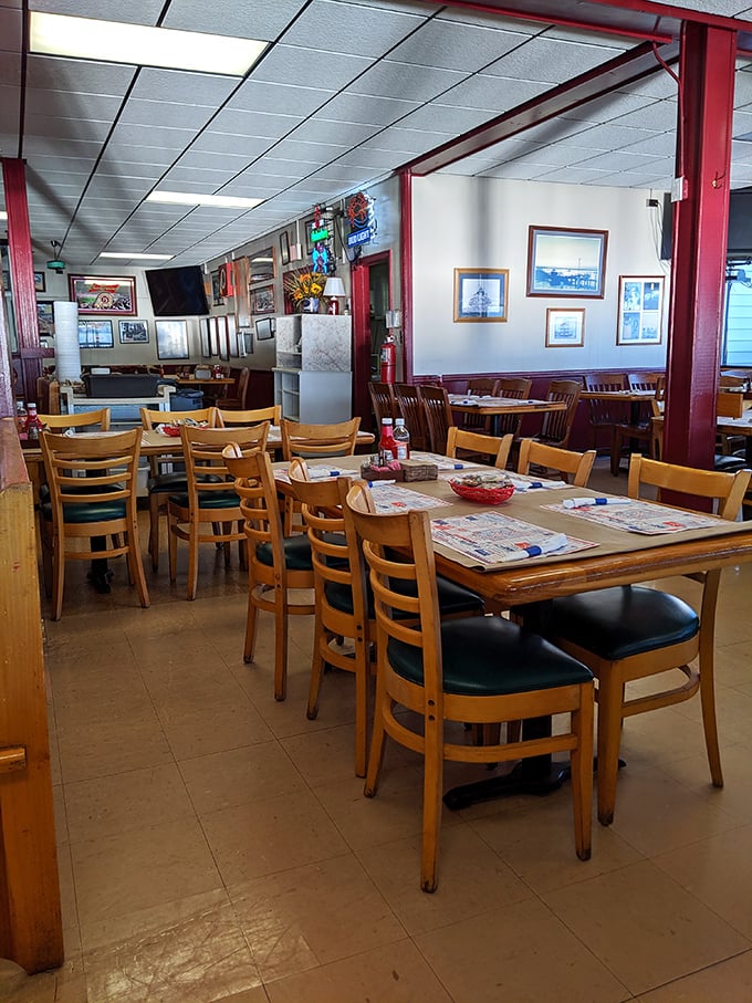 Tables patiently waiting for the next round of seafood lovers. The maritime artwork reminds you that your meal came from these very waters.