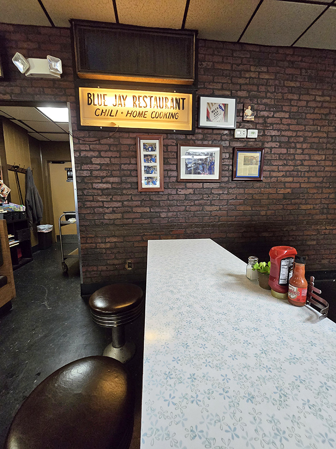 The exposed brick wall adorned with the Blue Jay sign tells stories of countless meals shared in this Cincinnati institution.