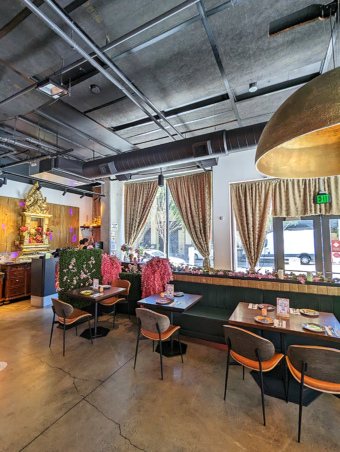 Industrial elements meet warm wood and lush greenery, creating a space that feels both thoroughly Portland and authentically Thai.