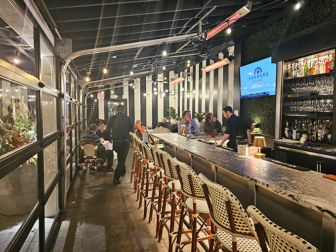 The sleek bar area stretches invitingly, with bistro chairs that practically whisper, "Stay awhile, the night is young."