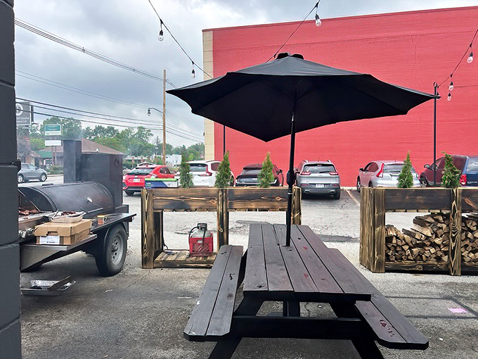 Picnic tables, shade umbrellas, and the smoker nearby&mdash;this isn't just outdoor seating, it's barbecue's natural habitat in its purest form.