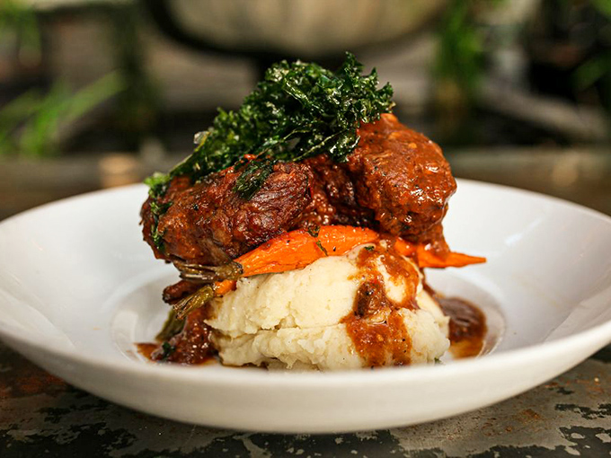 Short ribs so tender they practically surrender to your fork, nestled atop mashed potatoes that clearly went to finishing school.