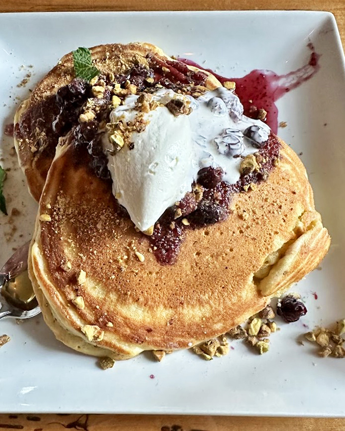 These pancakes don't merely arrive at your table &ndash; they make an entrance, topped with berries and cream that transform breakfast into an event worth dressing for.