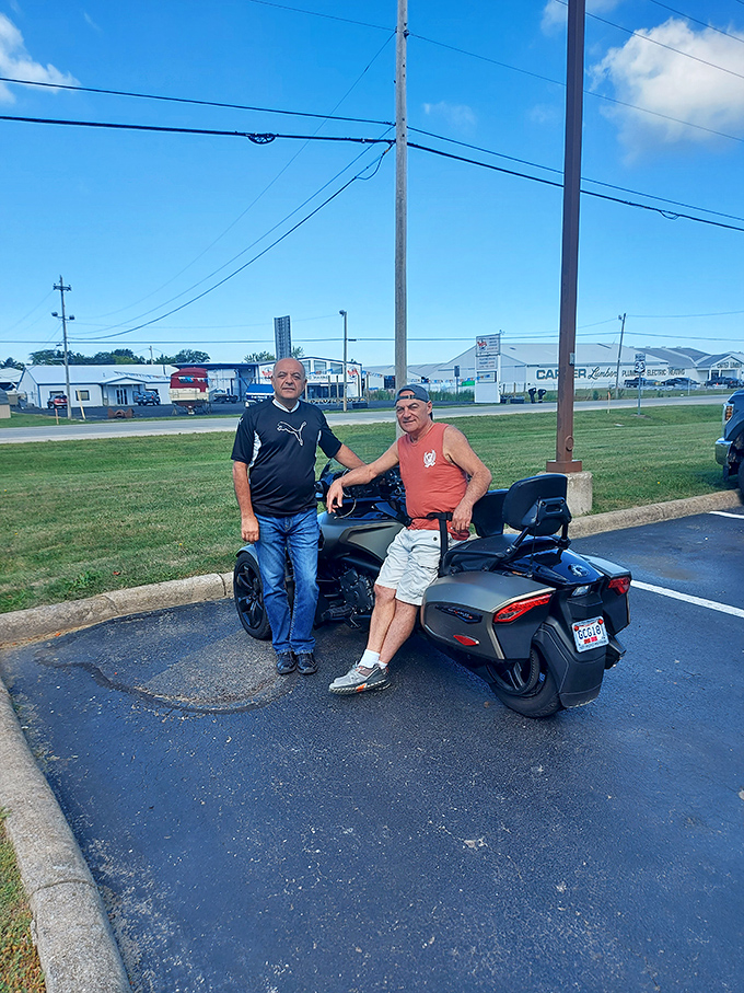 Even the parking area offers a glimpse of Lake Erie life, where motorcycles and conversations are part of the Harbor Light experience.