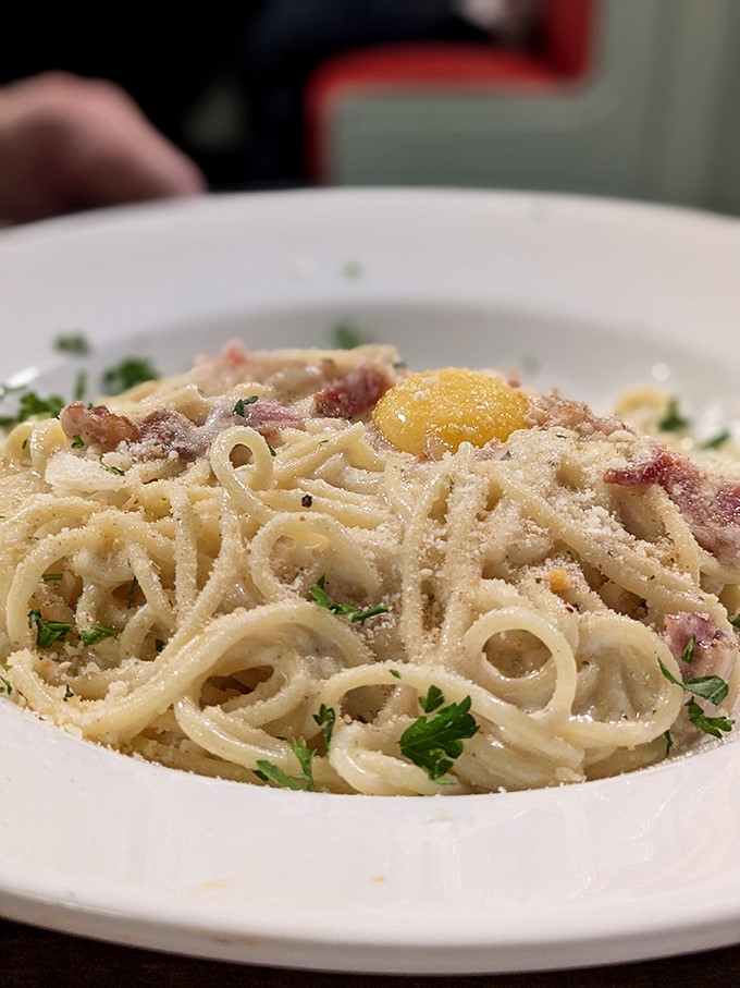 Carbonara that whispers "I'm worth every calorie." That egg yolk isn't just an ingredient&mdash;it's the golden ticket to pasta perfection.