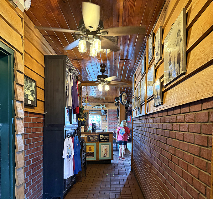 The hallway feels like walking through Florida's seafood history, where every faded photo and brick has earned its place.