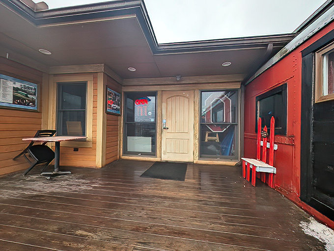 Even the entrance feels like stepping into another era. That wooden deck and scarlet trim say "welcome aboard" before you've even seen a menu.