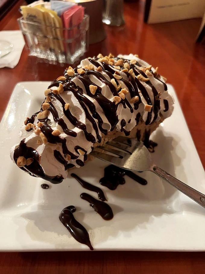 Peanut butter pie with chocolate drizzle that doesn't just end your meal&mdash;it creates a dessert memory that will haunt your dreams in the best possible way.