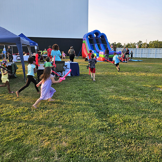 Pre-show entertainment includes inflatable fun, turning movie night into a full evening of family memories.