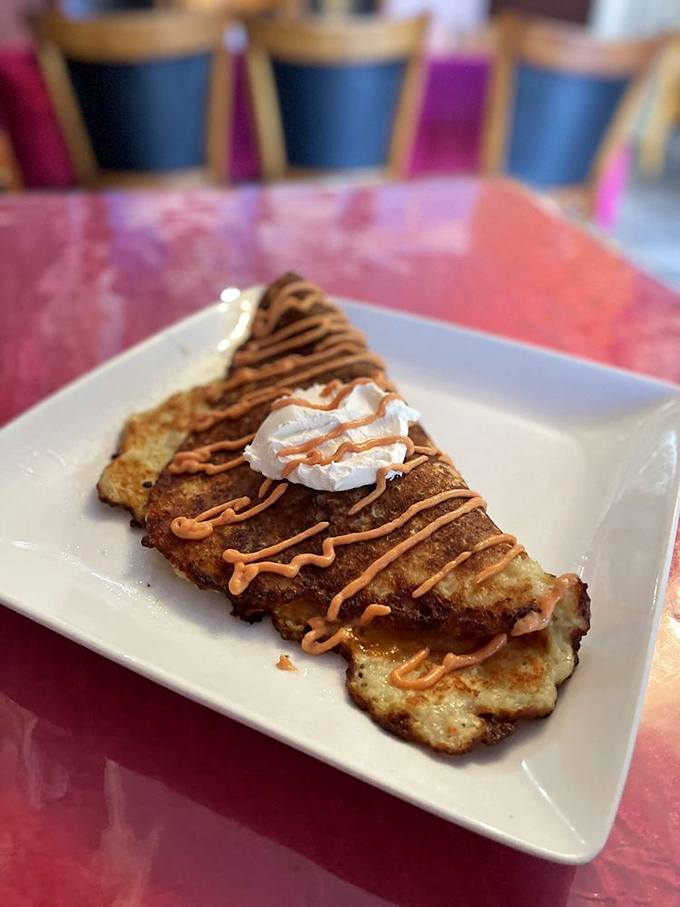 This isn't just a potato pancake &ndash; it's a crispy, golden canvas for sweet sauce and whipped cream, proving potatoes have a serious dessert potential. 