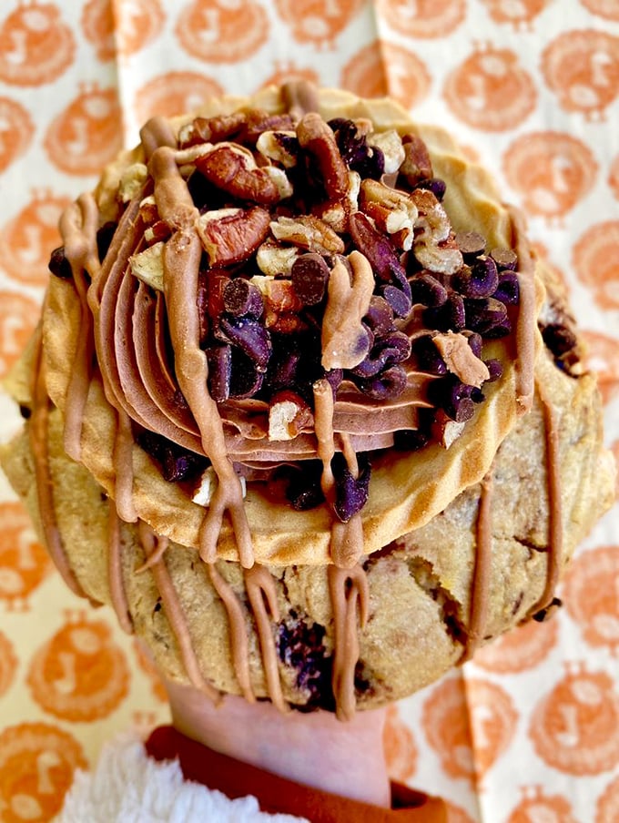 A cookie masterpiece crowned with chocolate frosting and nuts&mdash;proof that sometimes the best things in life require both hands and several napkins.