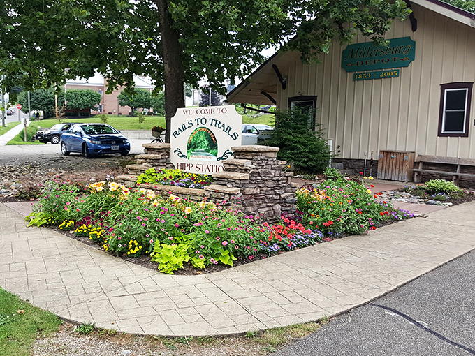 The Rails to Trails Hipp Station welcomes outdoor enthusiasts with a riot of colorful flowers, proving that even transit points can be beautiful.
