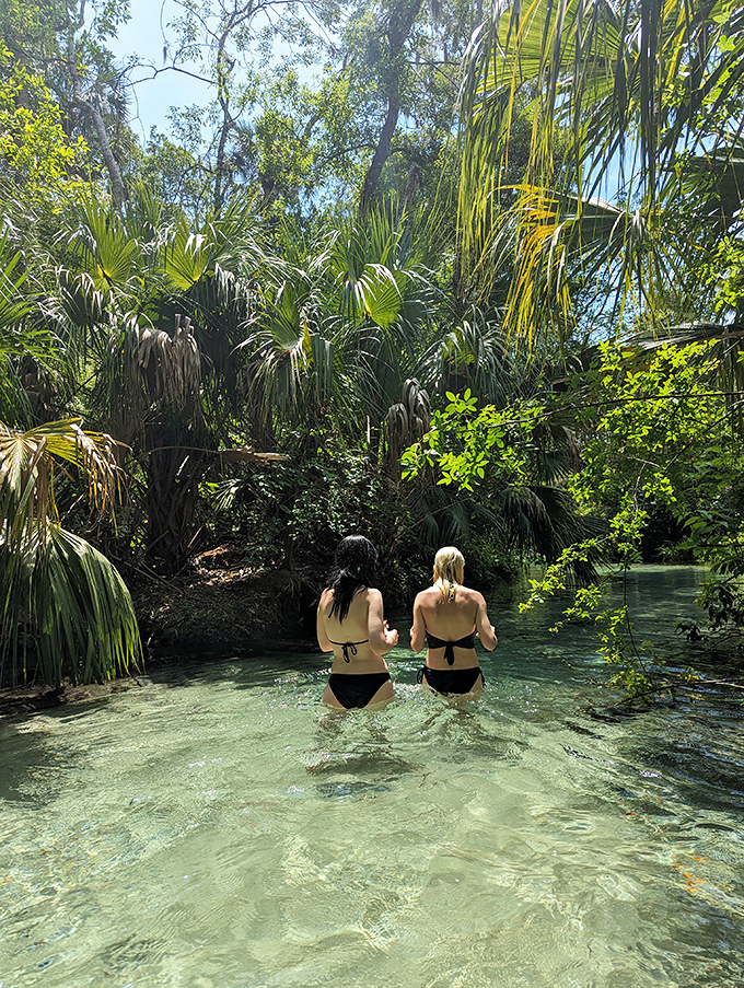 Two adventurers discovering that the best social media is actually no social media&mdash;just pure spring water and palm tree canopies.
