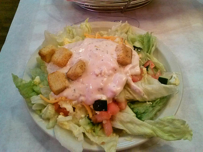 A house salad that's trying its best to convince you it belongs at this meat palace. Nice effort, lettuce. We see you.